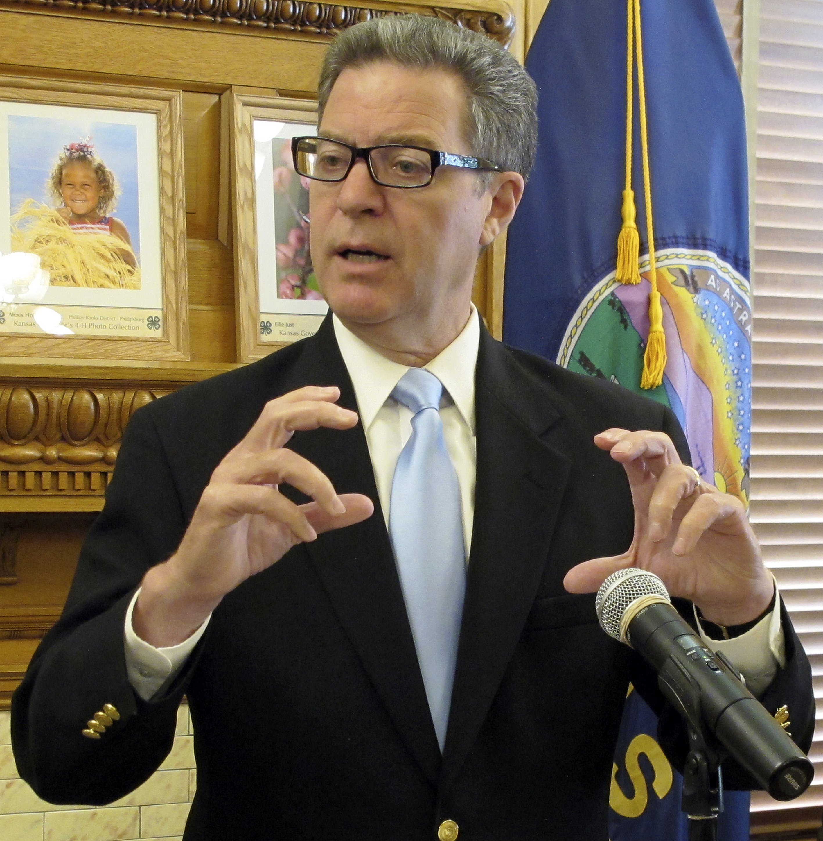 Kansas legislators repudiate governor by overriding tax veto | AP News