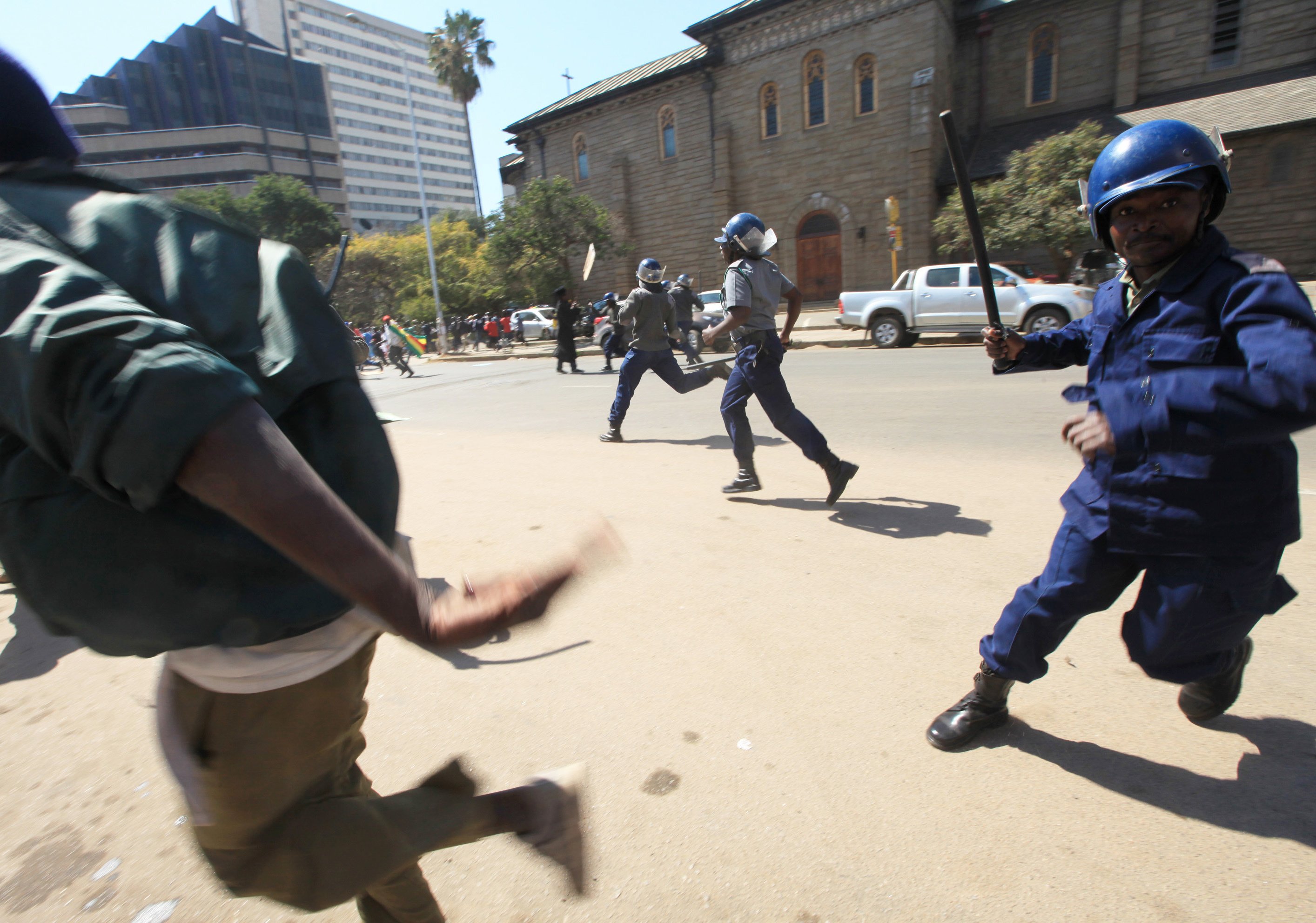 Zimbabwe police use tear gas to violently break up protests | AP News