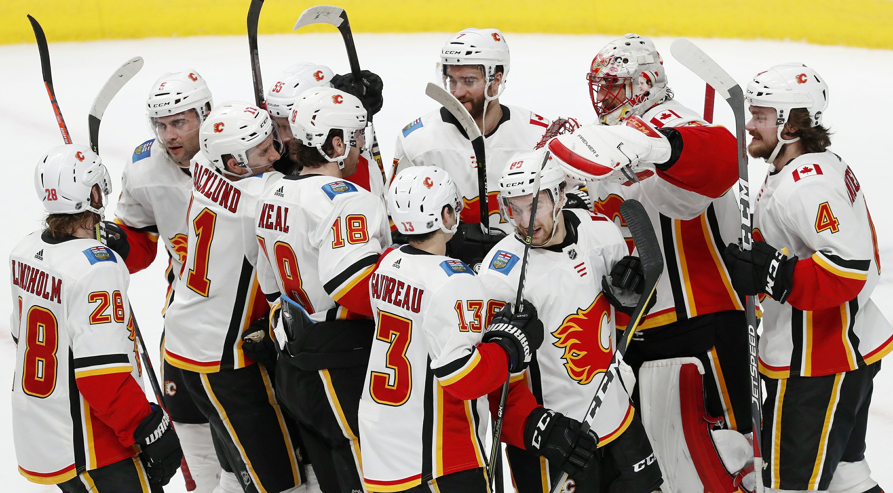Flames top Sharks 5-3, clinch conference, division crowns | AP News