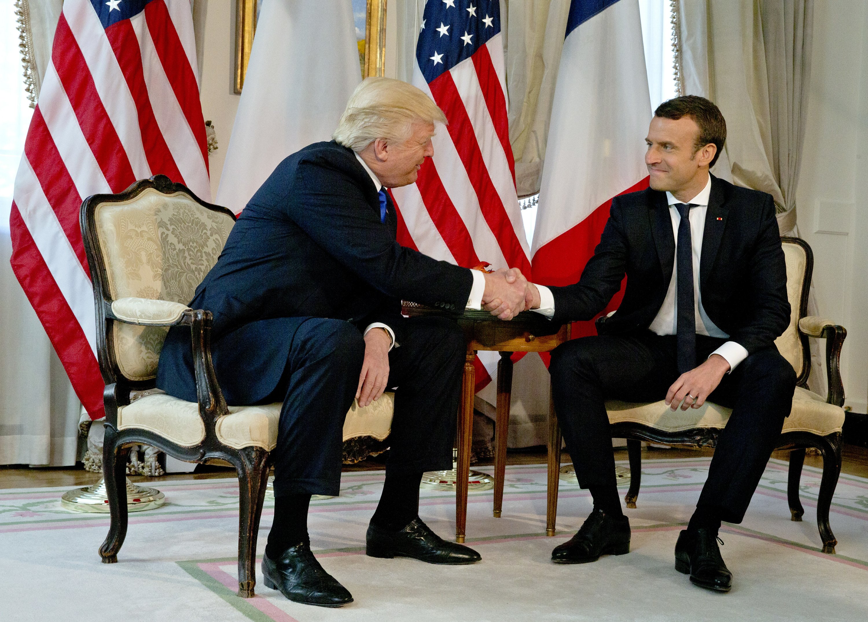 Trump handshake showdown: France's Macron just won't let go | AP News