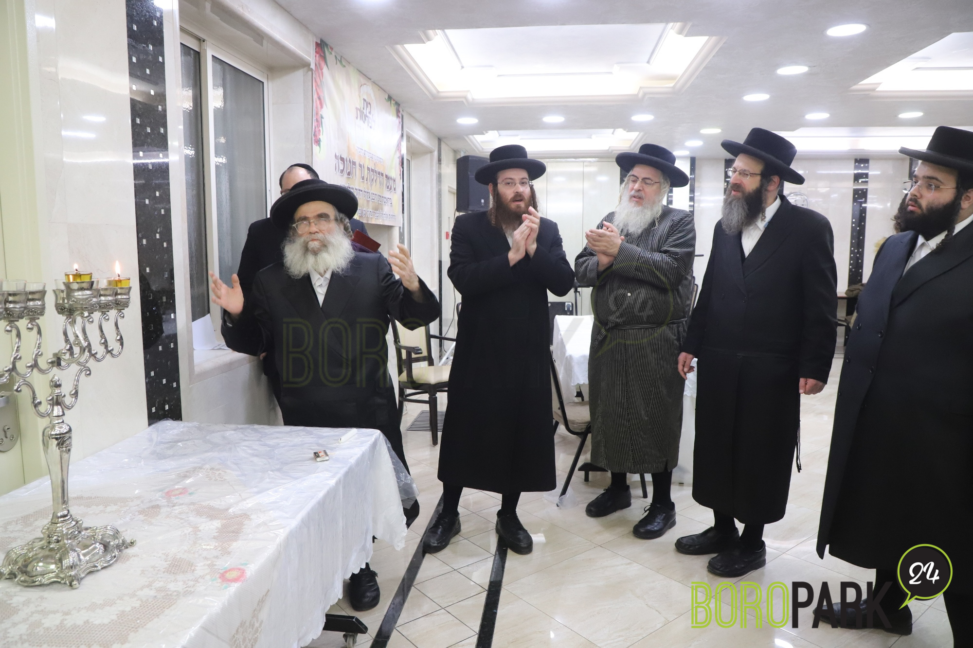 Hagoan Rabbi Gamliel Rabinowitz lighting the Menorah at the Beis ...