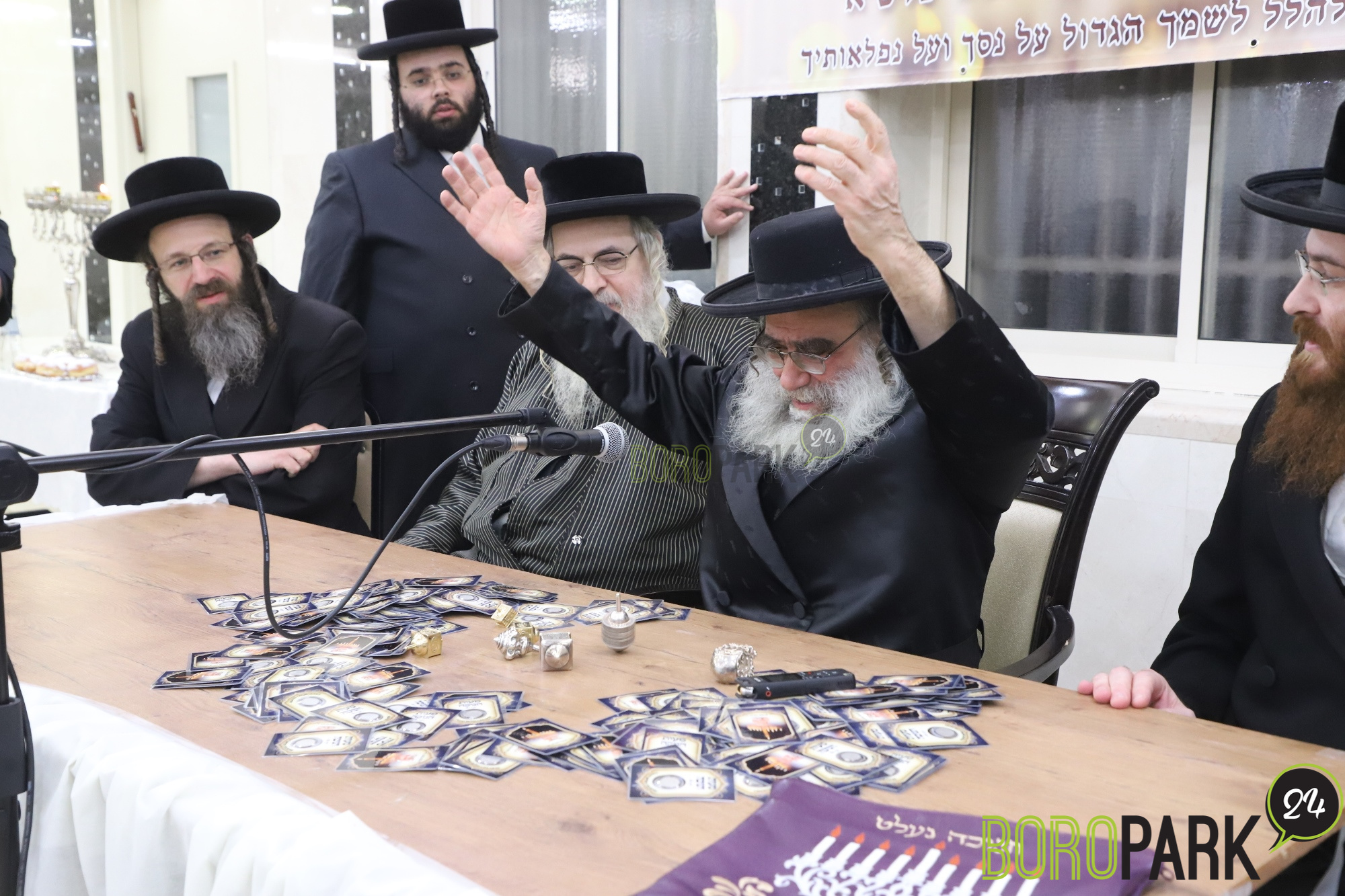 Hagoan Rabbi Gamliel Rabinowitz lighting the Menorah at the Beis ...
