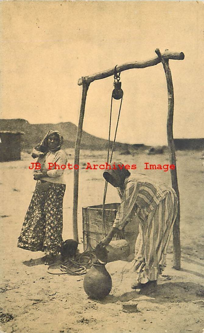 Native American Moqui Indian Woman Filling Water Jugs at a Well in ...