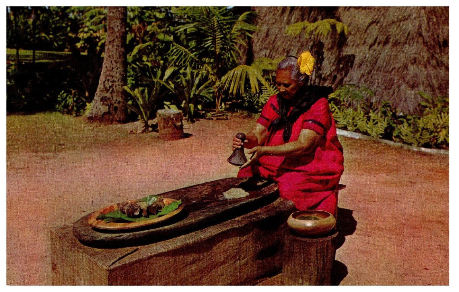 Hawaiian woman pounding taro into poi at Ula Mau Village Hawaii ...