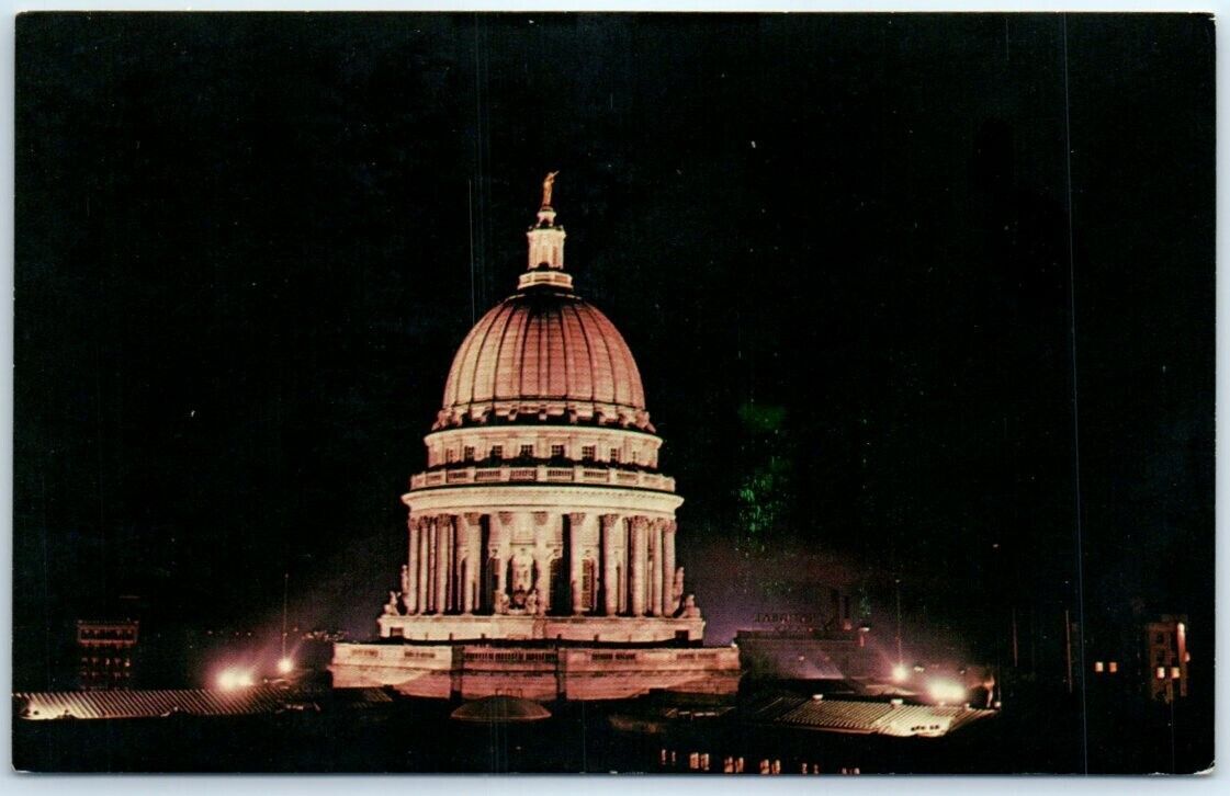 Unusual night view showing lighted dome of the State Capitol Building ...