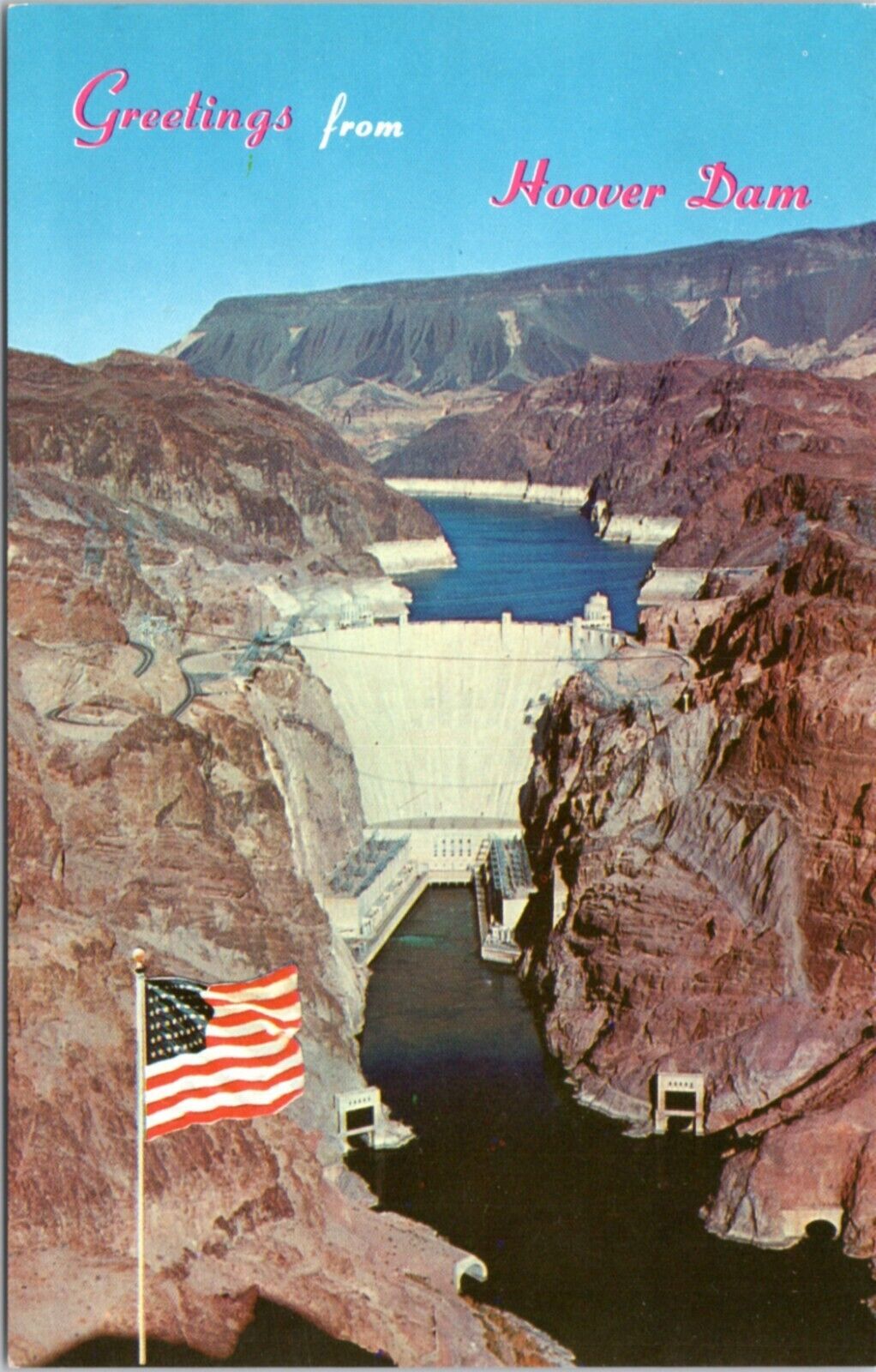 Postcard NV - Greetings from Hoover Dam -- aerial of dam with US Flag ...
