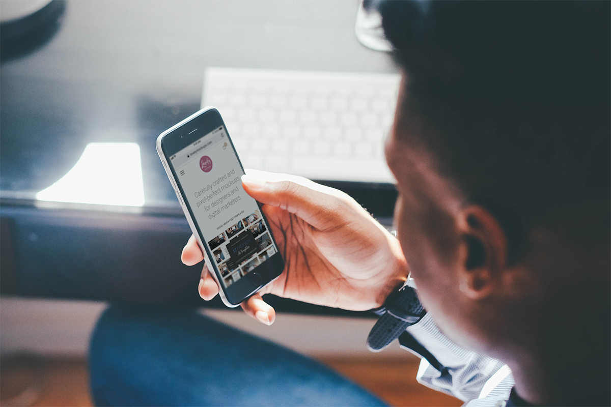 Man viewing on iphone screen - Lovely Mockups
