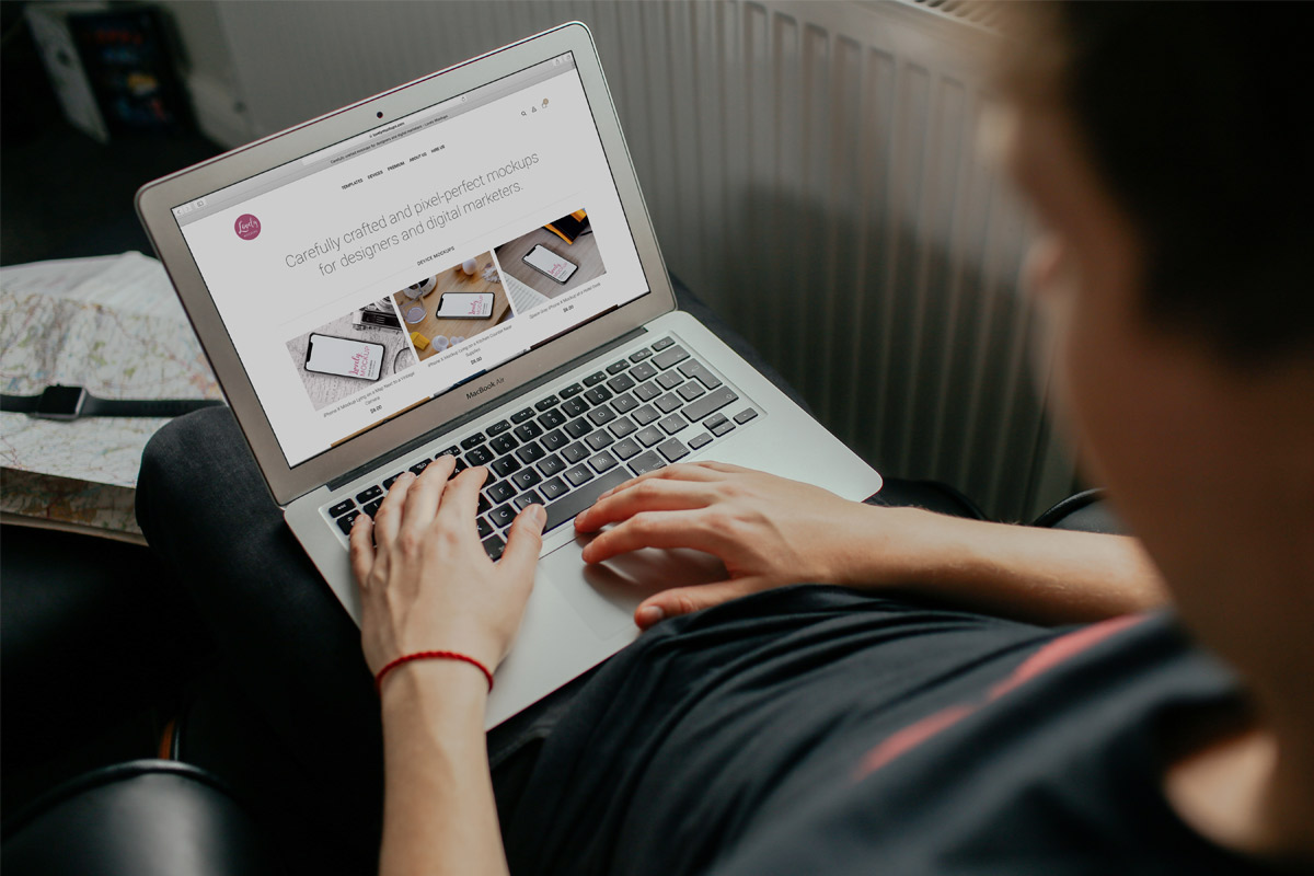 Young Man Working on his Macbook Air Mockup - Lovely Mockups