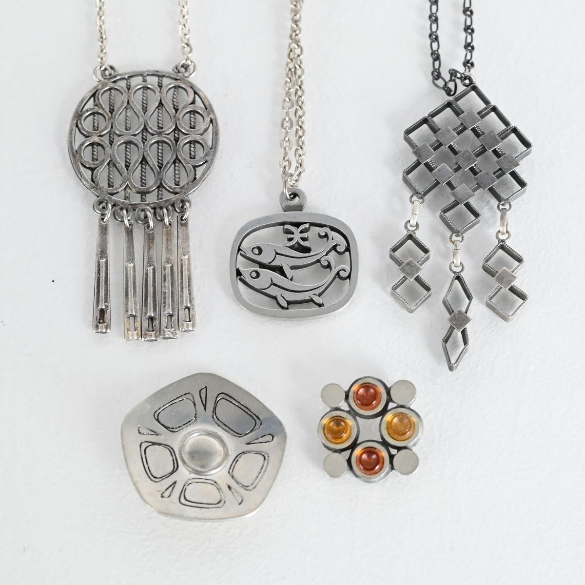 3 halsband med hängen, 2 broscher, tenn, stål (106880) — Luleå Auktionsverk