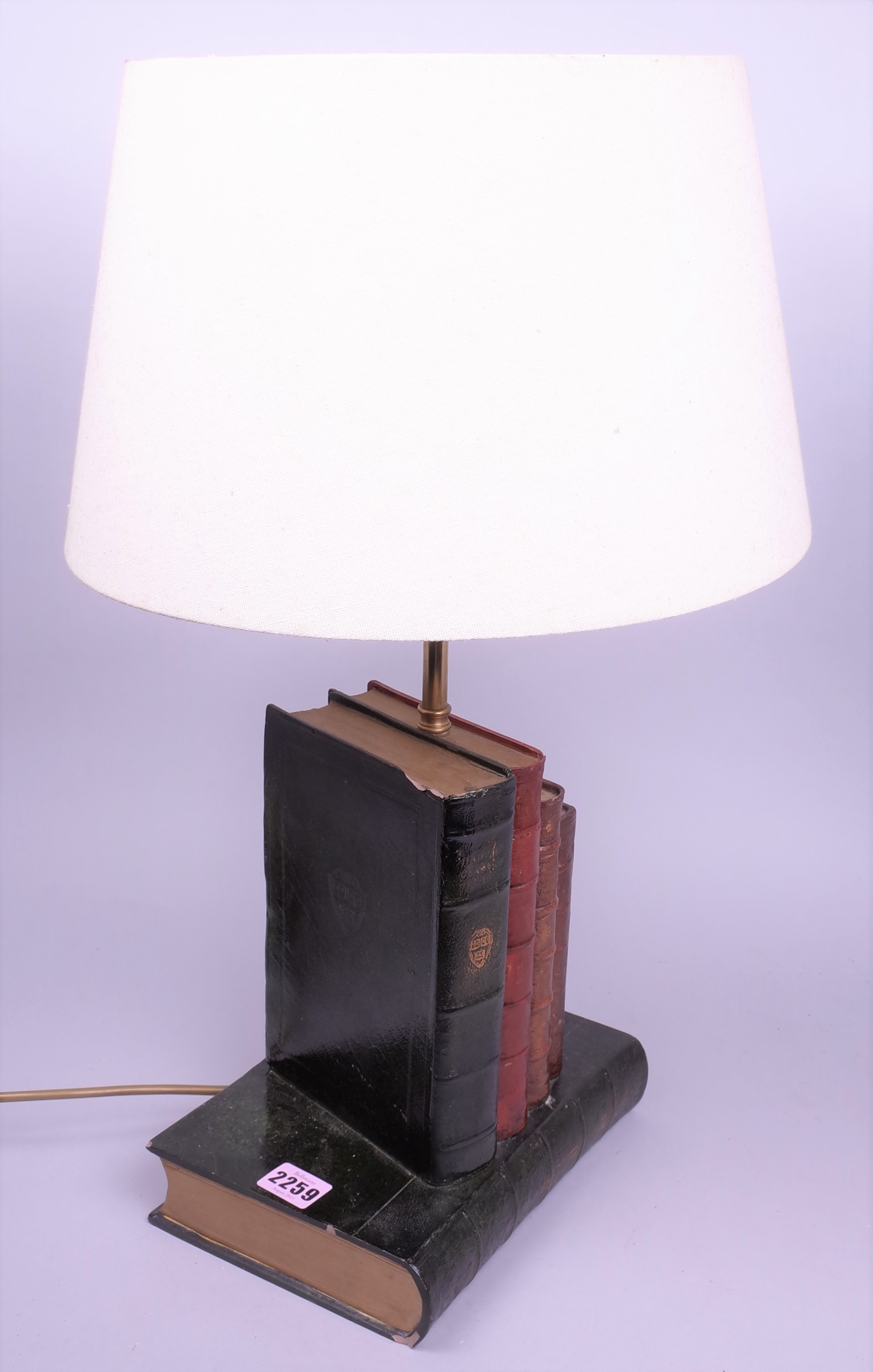 A modern plaster table lamp formed as a stack of books | Barnebys
