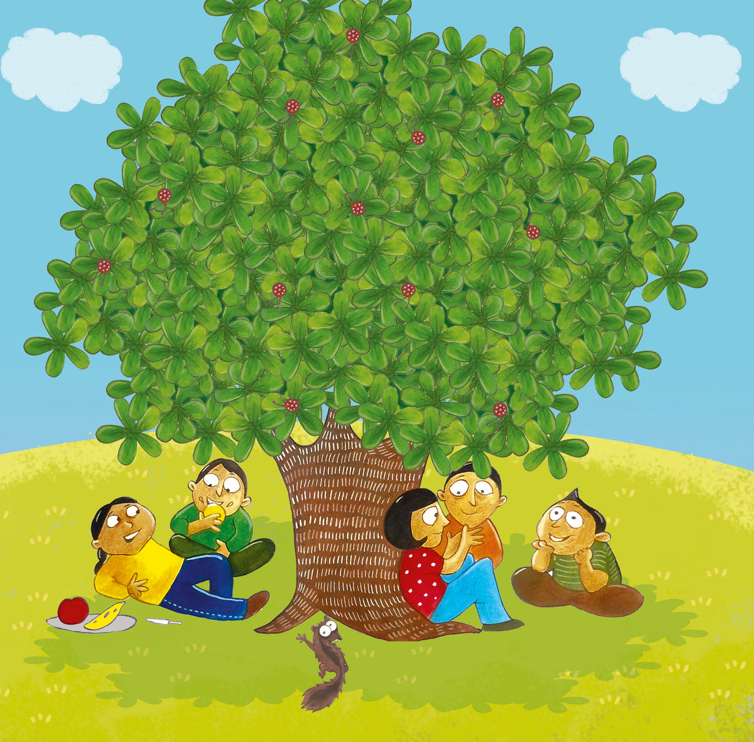Children sitting below a tree and eating fruits